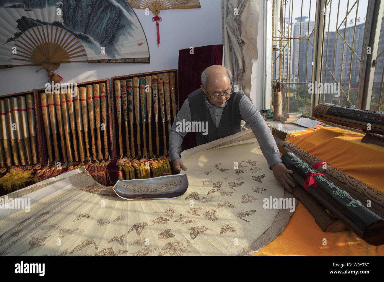 Handmade grass cloth folding fan Stock Photo - Alamy