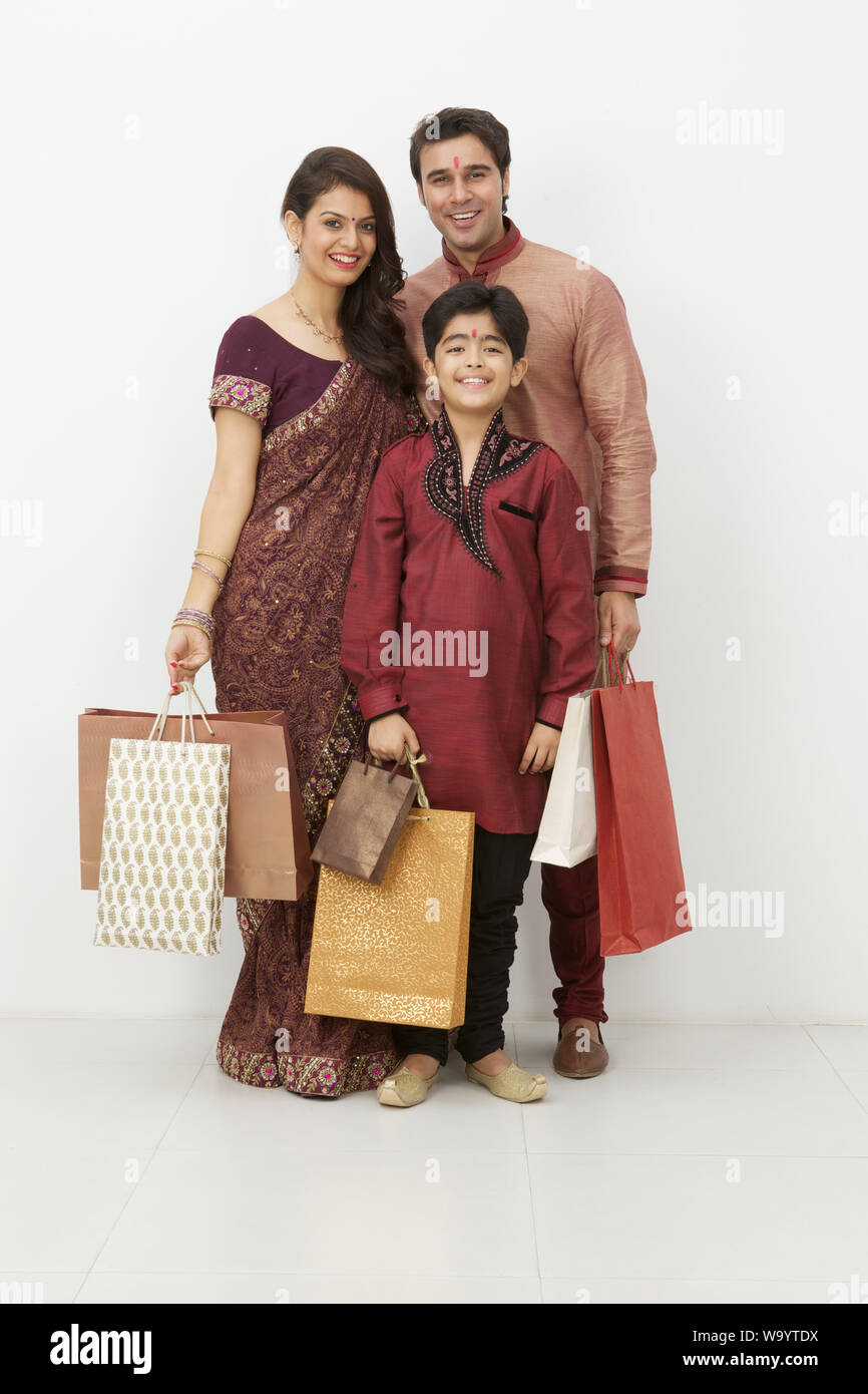 Family carrying shopping bags hi-res stock photography and images - Alamy
