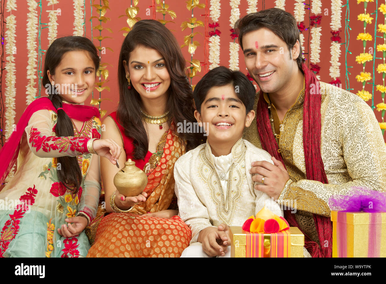Family celebrating Diwali and collecting money Stock Photo - Alamy