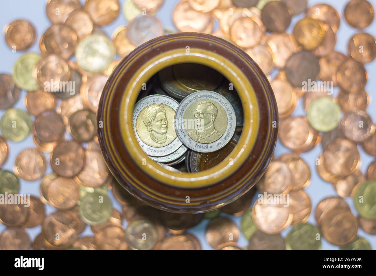 Thai coins in a jar and a king and queen on a coin Stock Photo - Alamy