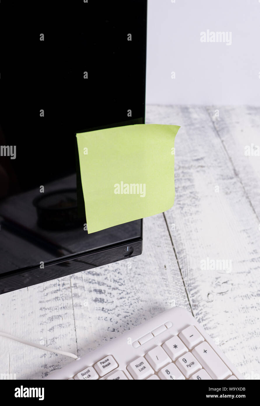 Notation paper taped to black computer monitor screen near white ...