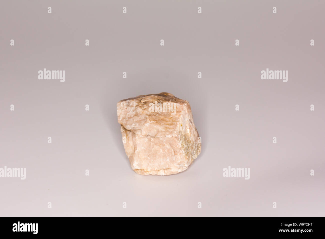 Natural beige stone isolated on white background Stock Photo - Alamy