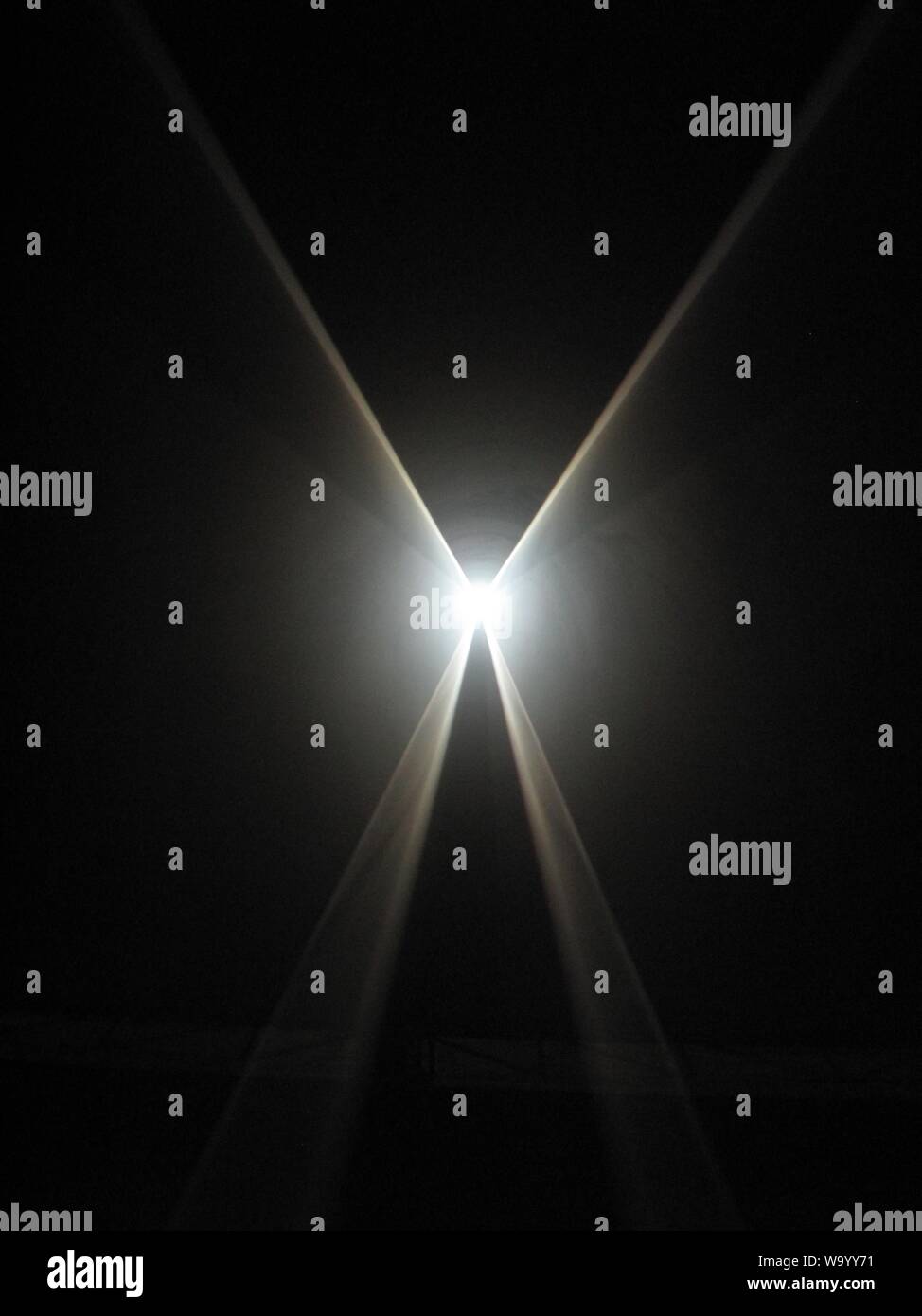 Vertical shot of rays of light wiht a black background Stock Photo - Alamy