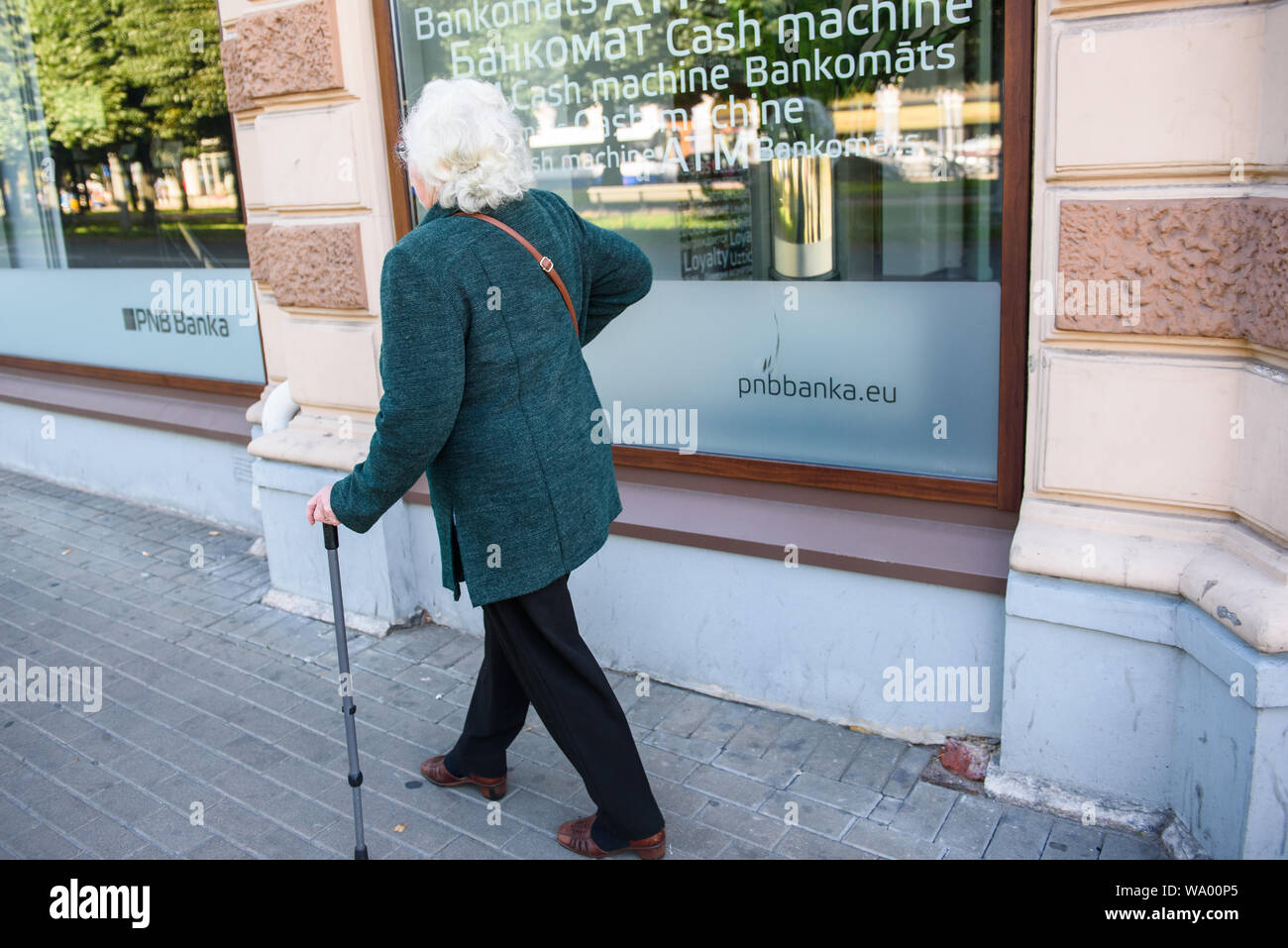 RIGA, Latvia. 16th Aug, 2019. Seniors are looking into the window and ...
