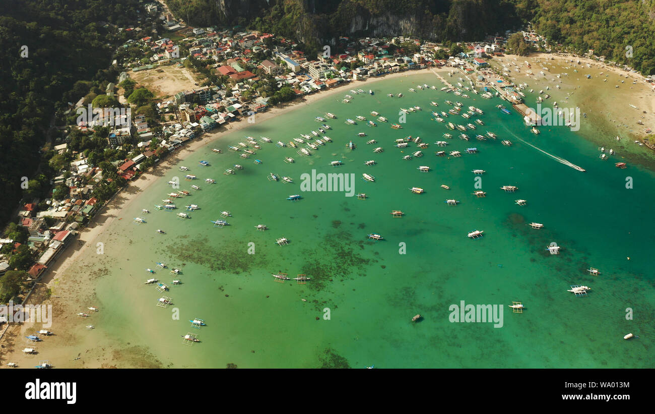 Town El nido on the coast with bay and lot tourist boats, Palawan ...