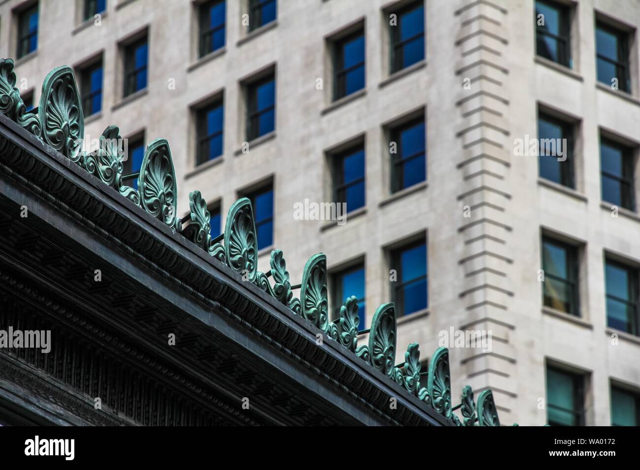Selective focus shot of a building's roof with a blurred white building ...