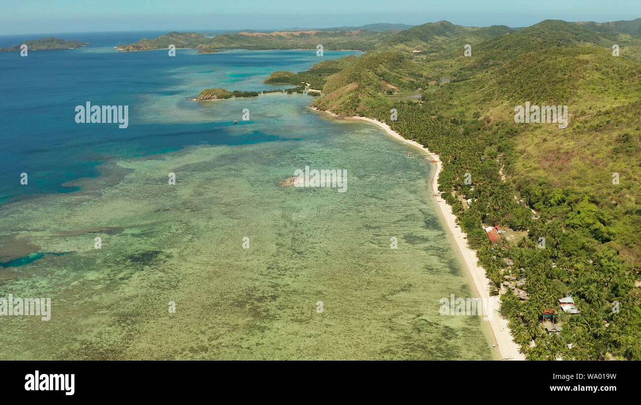 Aerial view tropical island with beach, coral reef and blue lagoon ...