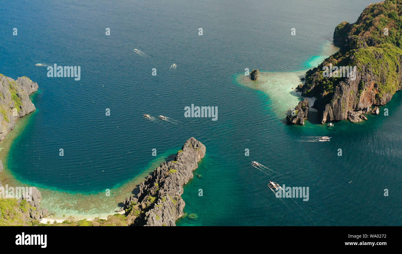 Cove with tourist boats and the tropical islands. Seascape with ...