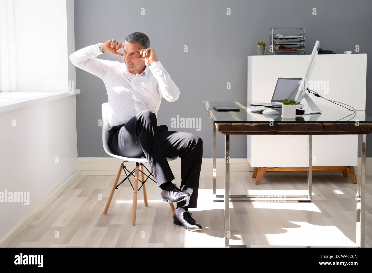 Mature man stretching desk hi-res stock photography and images - Alamy