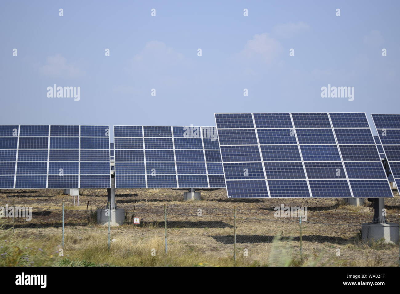 Solar power station in arid area under clear blue sky. Solar power ...