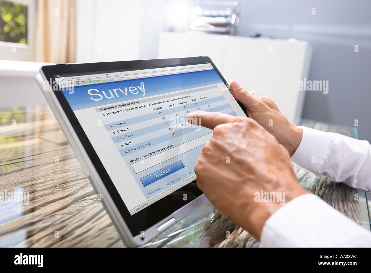 Close-up Of Businessman Looking At Online Survey Form On Digital Tablet ...