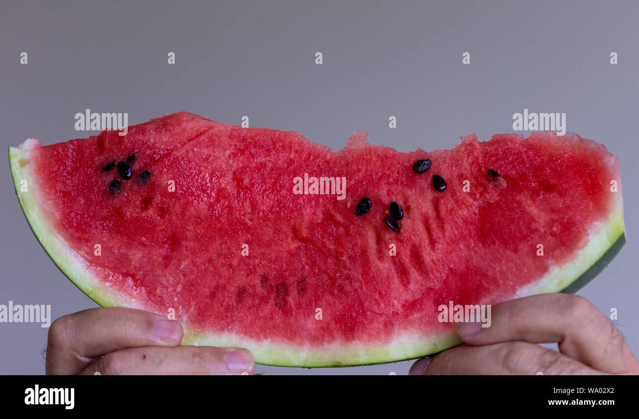 summer fruit watermelon, male hands holding a slice of watermelon Stock ...