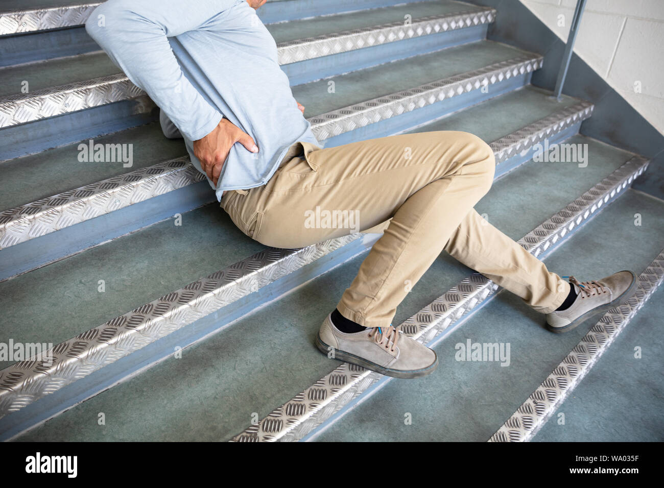 Mature Man Lying On Staircase After Slip And Fall Accident Stock Photo ...