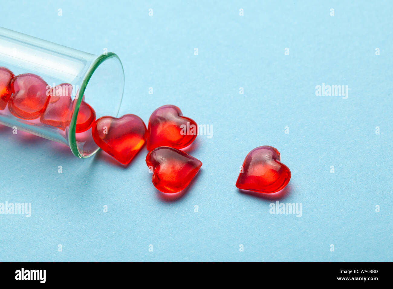 Hearts and test tube. Baby from tube vitro glass. Artificial ...