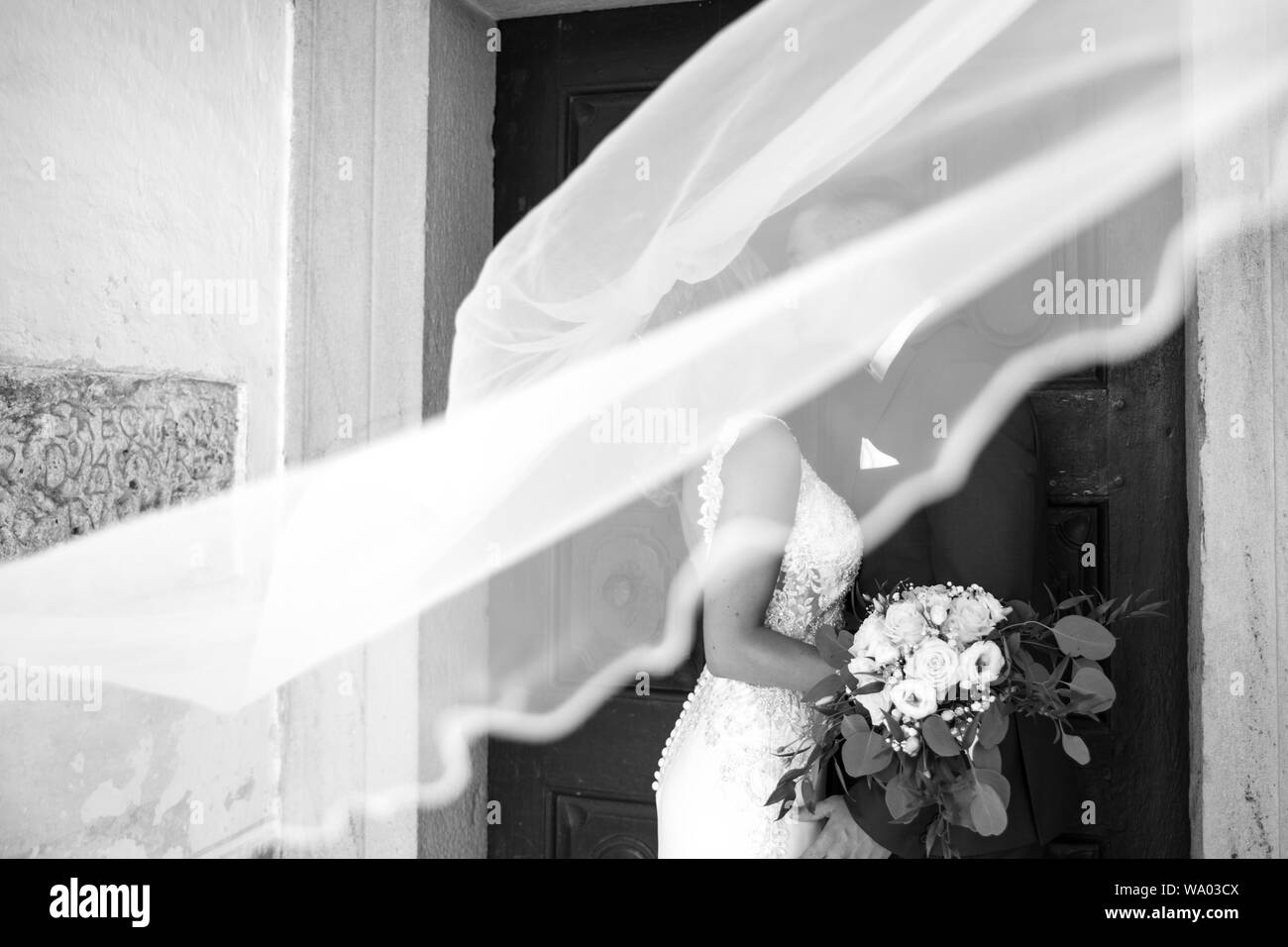 The kiss. Bride and groom kisses tenderly in the shadow of a flying ...