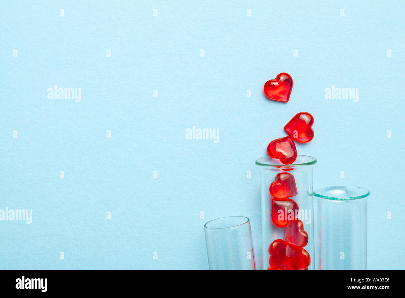 Hearts and test tube. Baby from tube vitro glass. Artificial ...