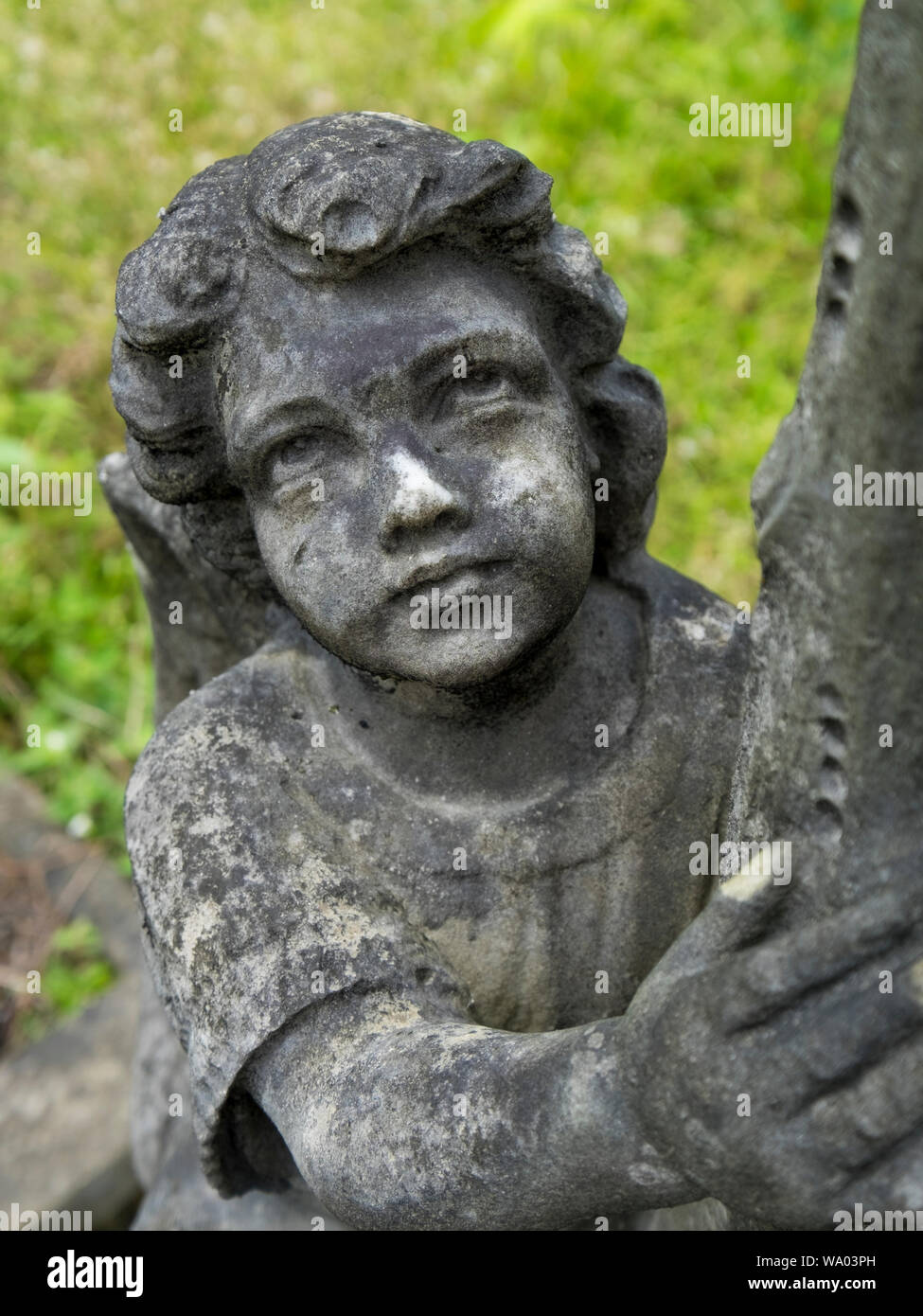 A small angel statue in an old British cemetery in Kuching, Malaysia ...
