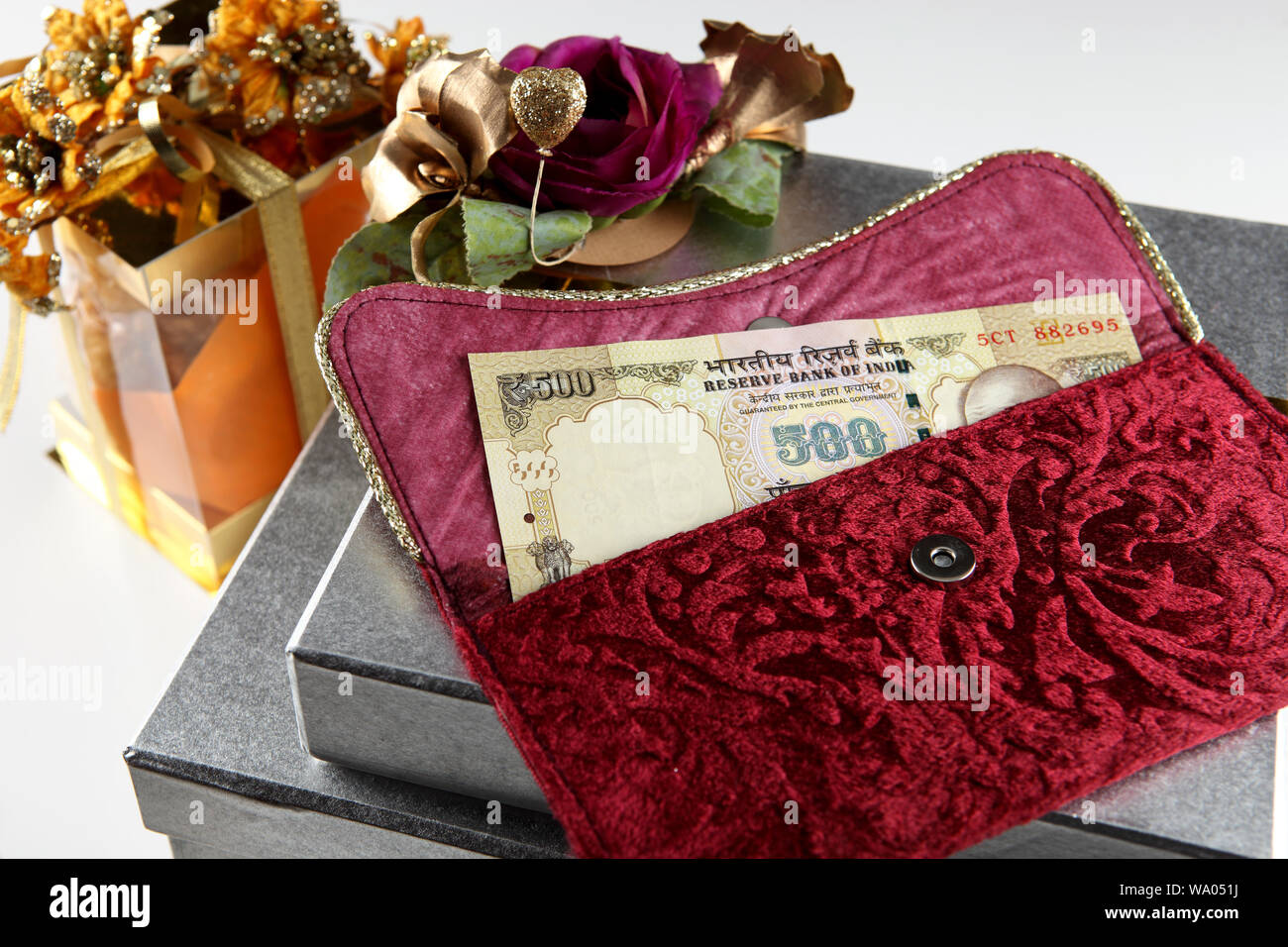 Purse with banknote on the stack of gift boxes Stock Photo - Alamy