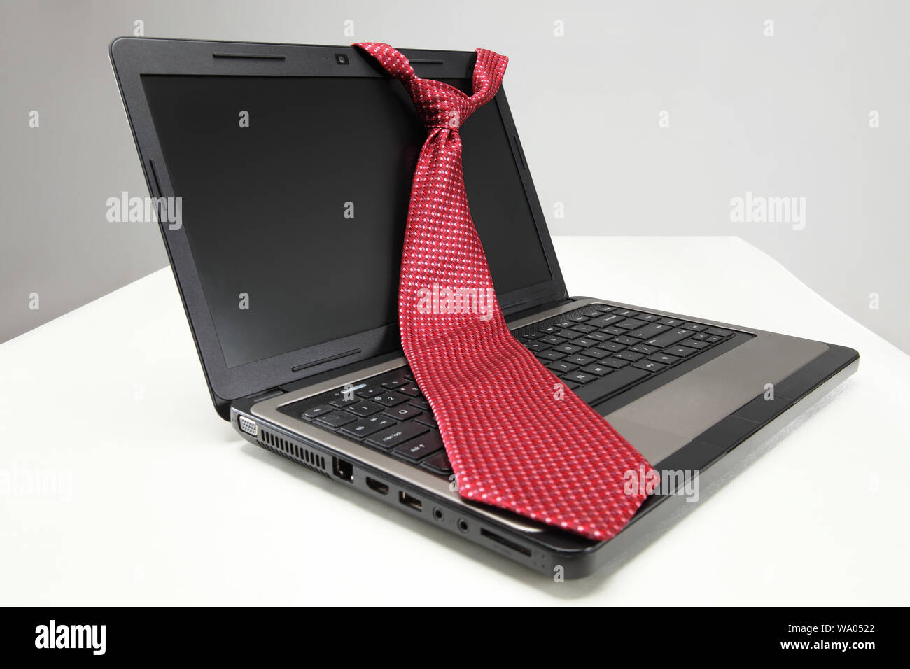 Tie on a laptop Stock Photo - Alamy