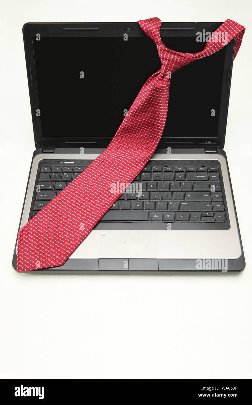 Tie on a laptop Stock Photo - Alamy