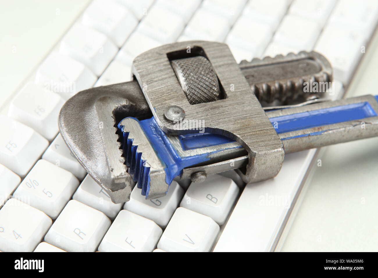 Pipe wrench on a computer keyboard Stock Photo - Alamy