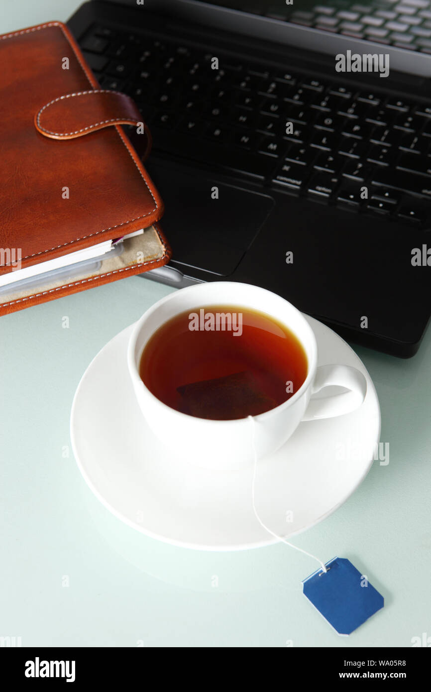 Herbal tea with diary and laptop Stock Photo - Alamy