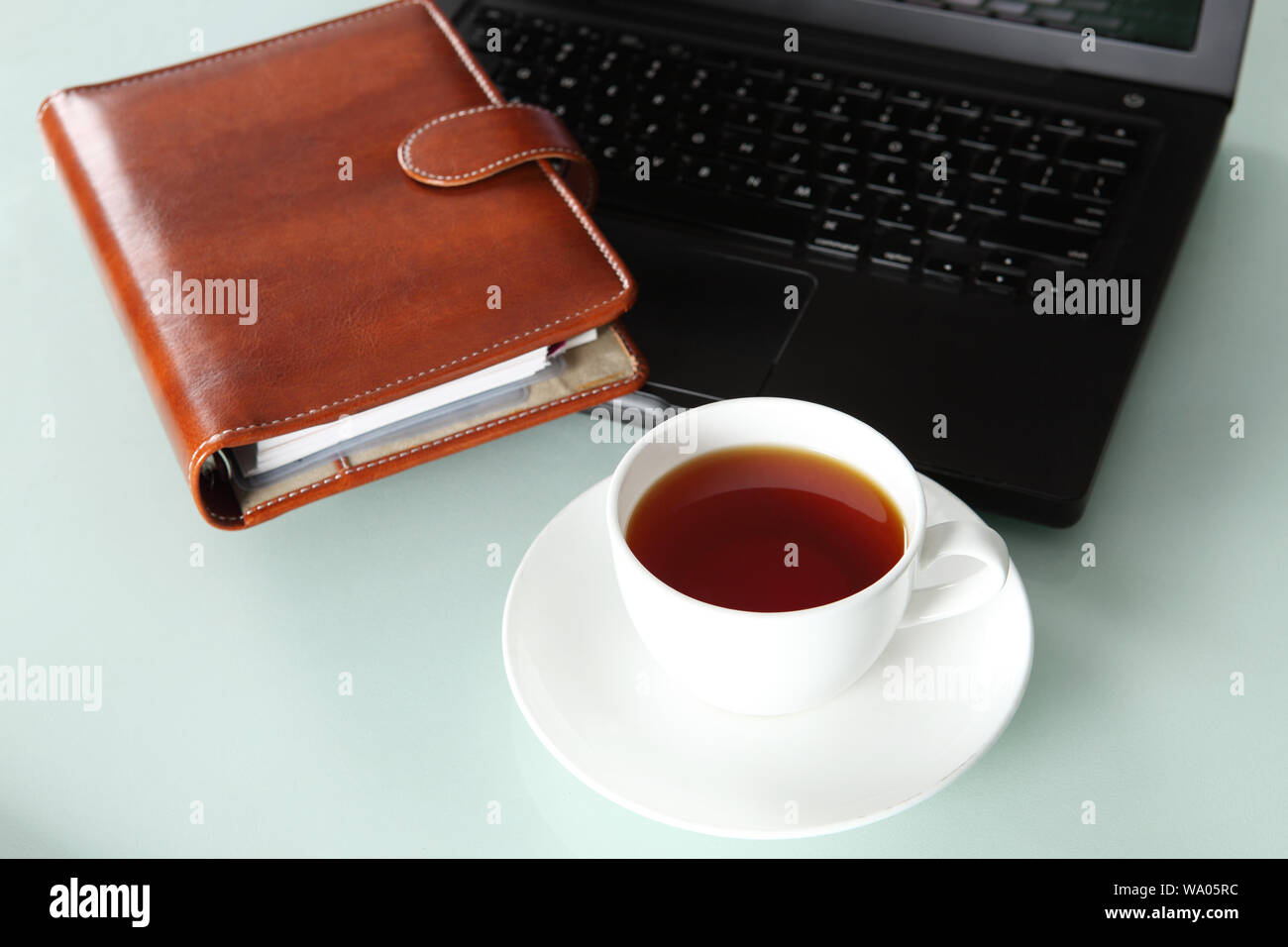Herbal tea and diary on a laptop Stock Photo - Alamy