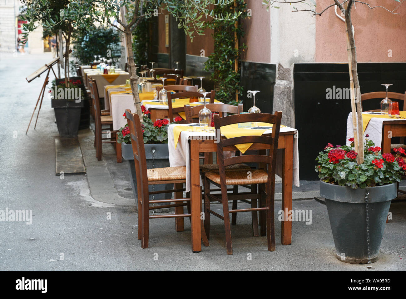 table setting on the street from a rustic restaurant in the old town of ...