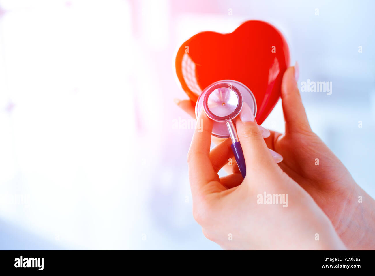 Doctor with a stethoscope examines the heart. Young doctor cardiologist ...