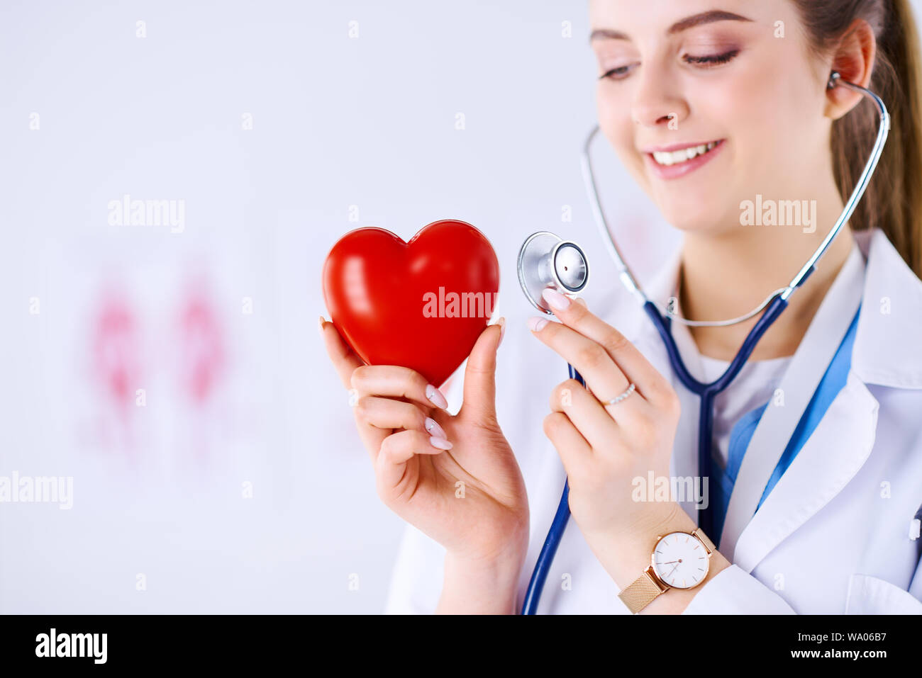 Doctor with a stethoscope examines the heart. Young doctor cardiologist ...