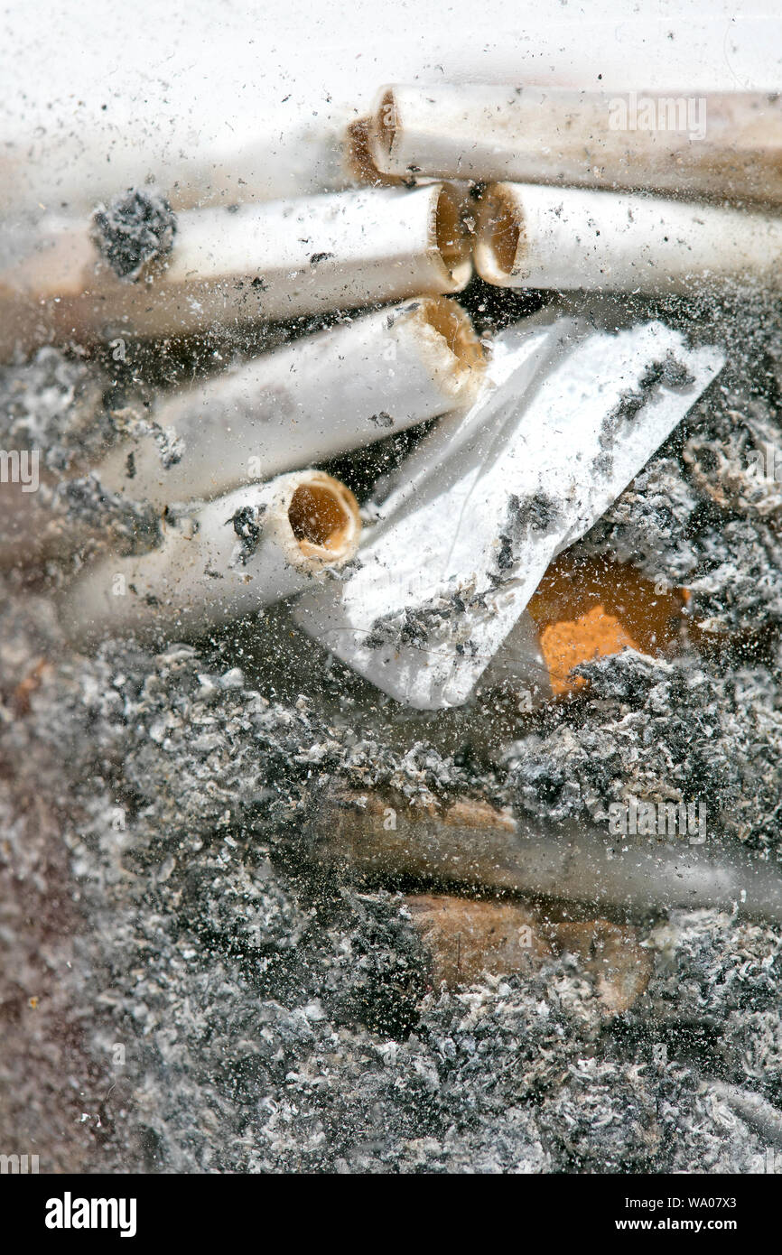 Ashes and joins from medical cannabis in glass macro background fifty ...