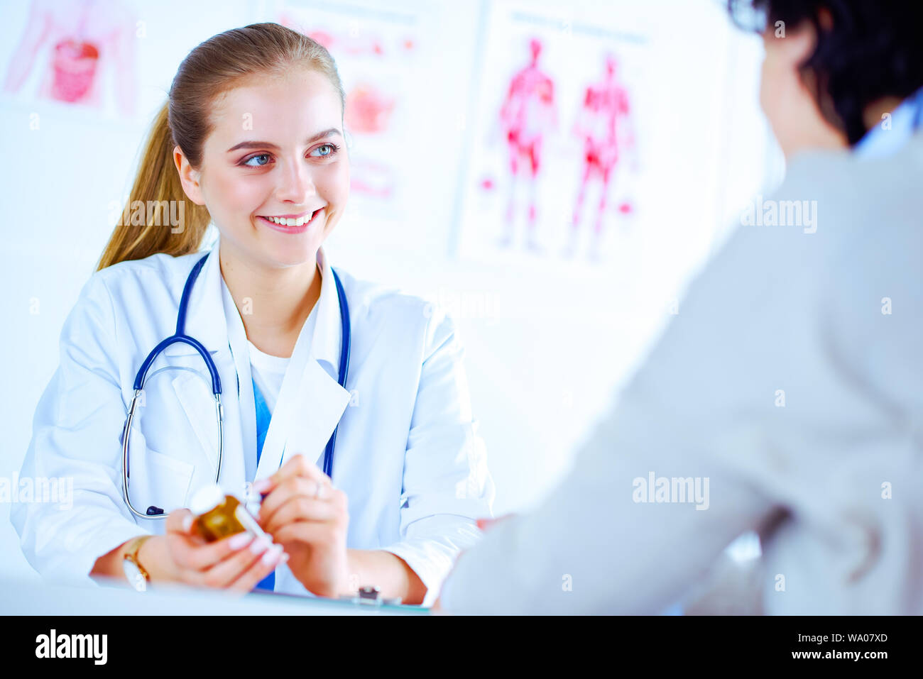 Doctor prescribing medication in office hi-res stock photography and ...