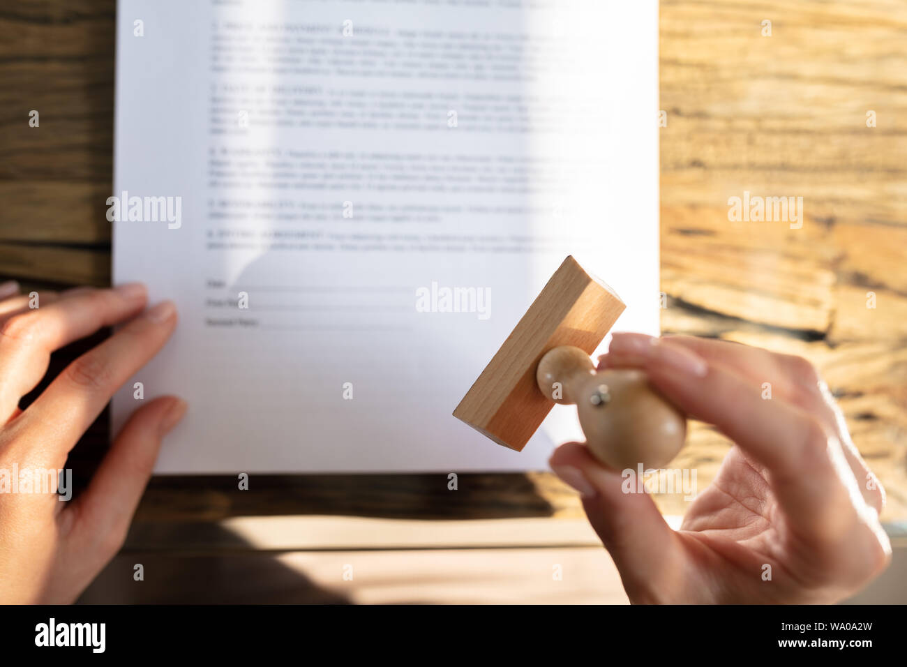 Close-up Of Businesswoman's Hand Stamping Approved On Contract Paper ...