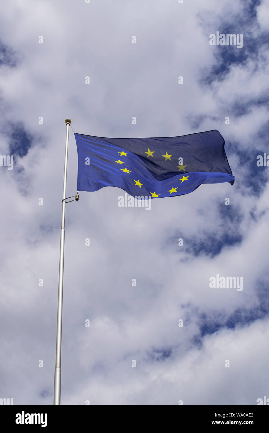 European Union flag waving, with clouds background Stock Photo - Alamy