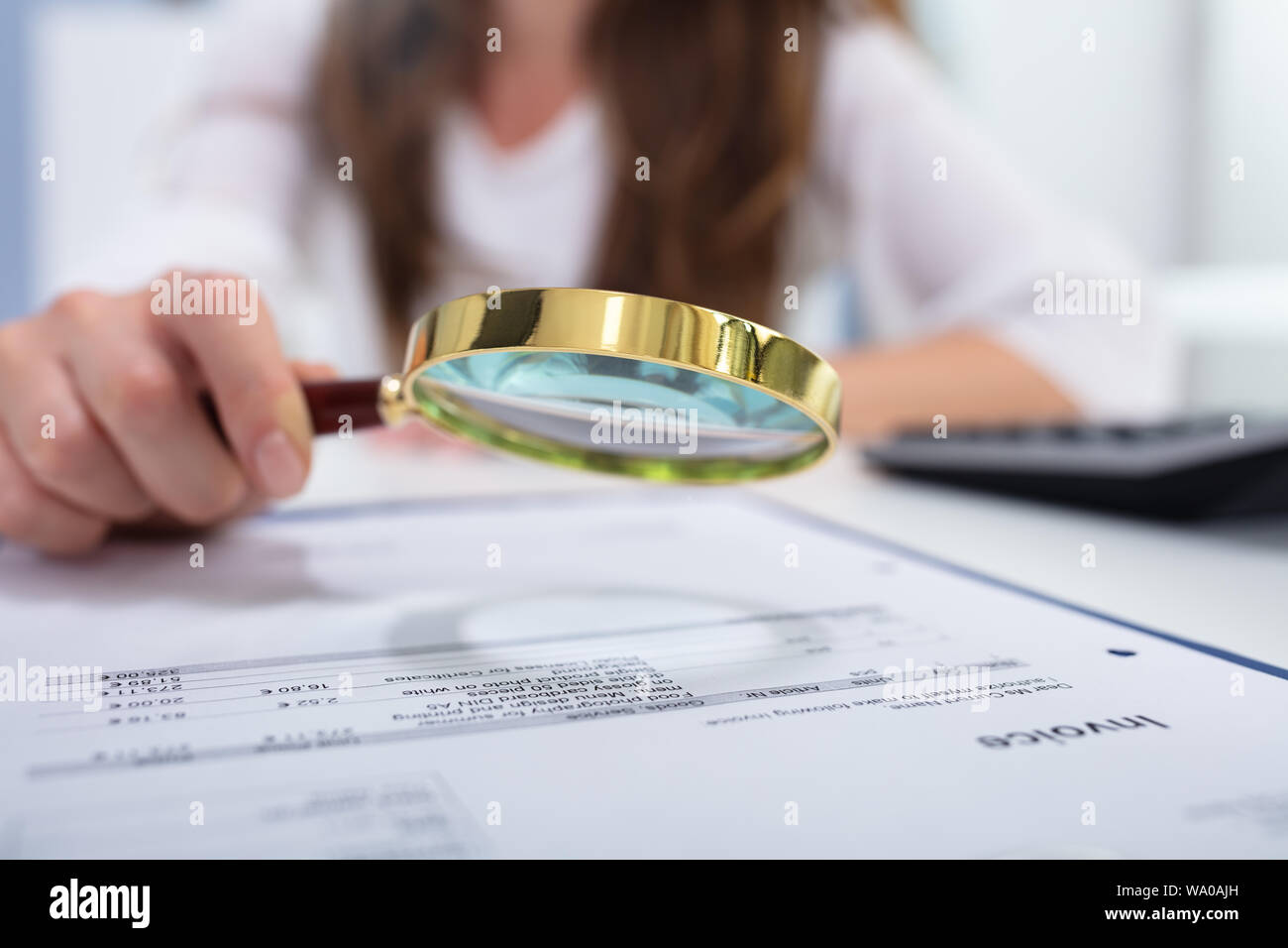Close-up Of A Businesswoman Looking Invoice Through Magnifying Glass On ...
