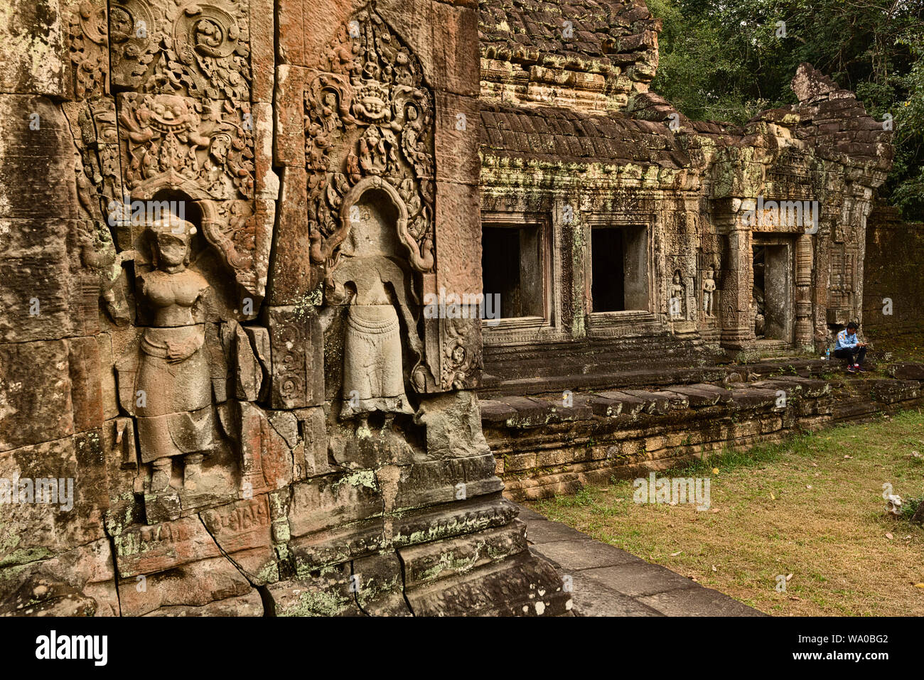 two statue of devata whose face was sliced in Preah Khan temple, Khmer ...