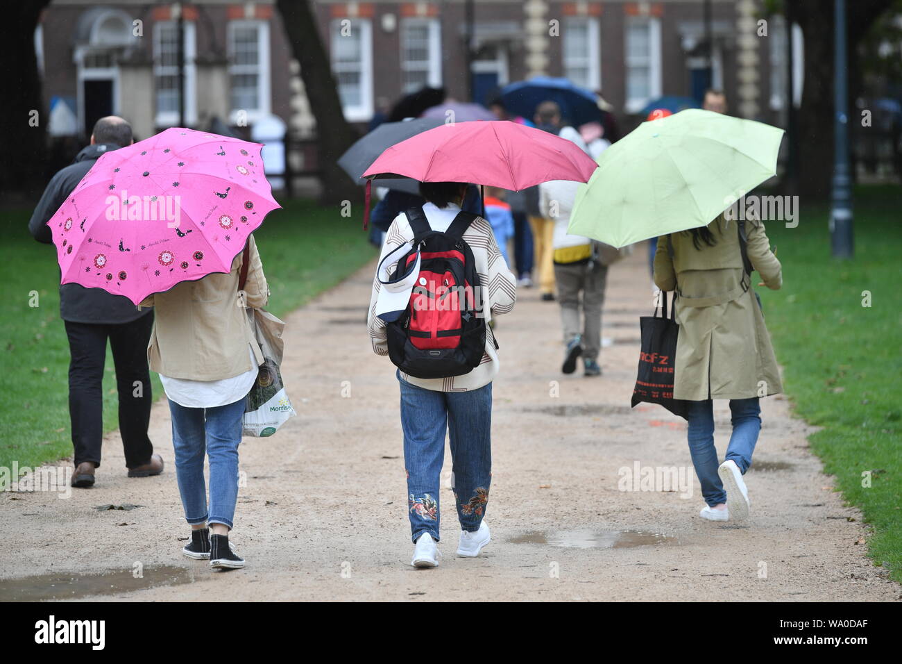 People use umbrellas to shelter from the rain in Bristol city centre ...