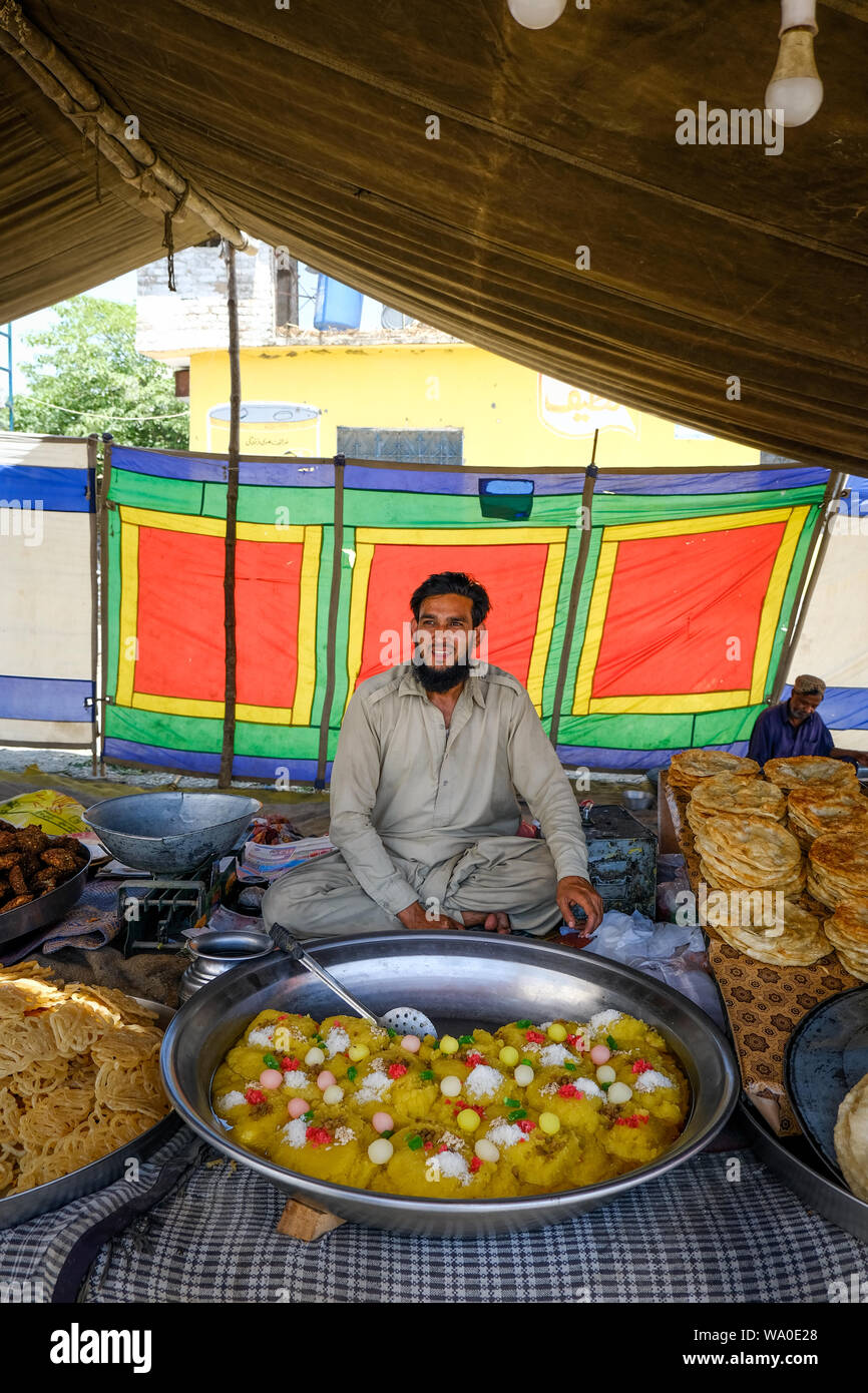 Street Seller selling traditional Pakistani sweet dish made of Pumpkin ...