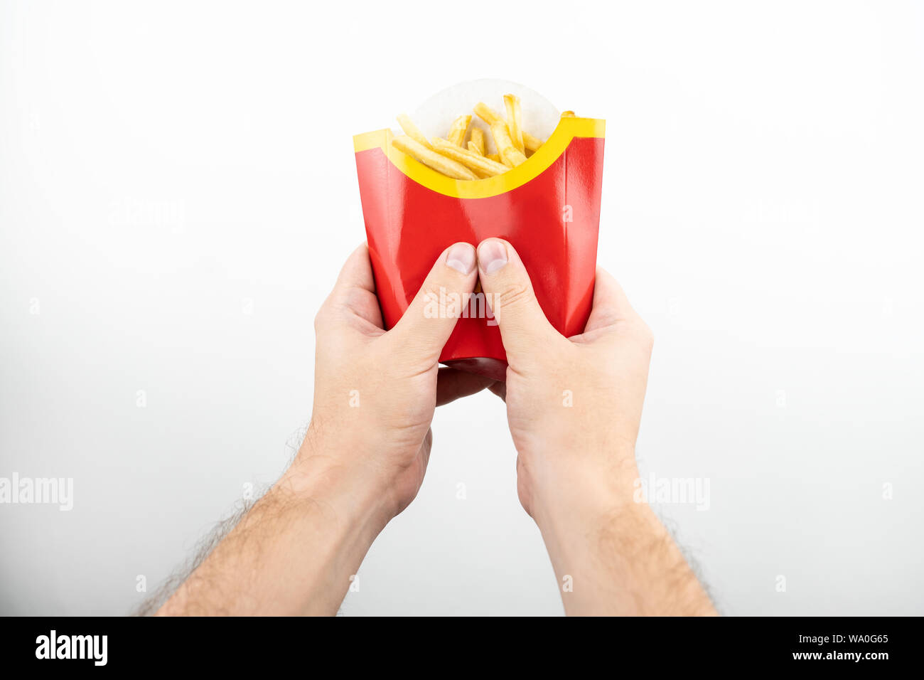 image of hands holding french fries from fast food restaurant on ...