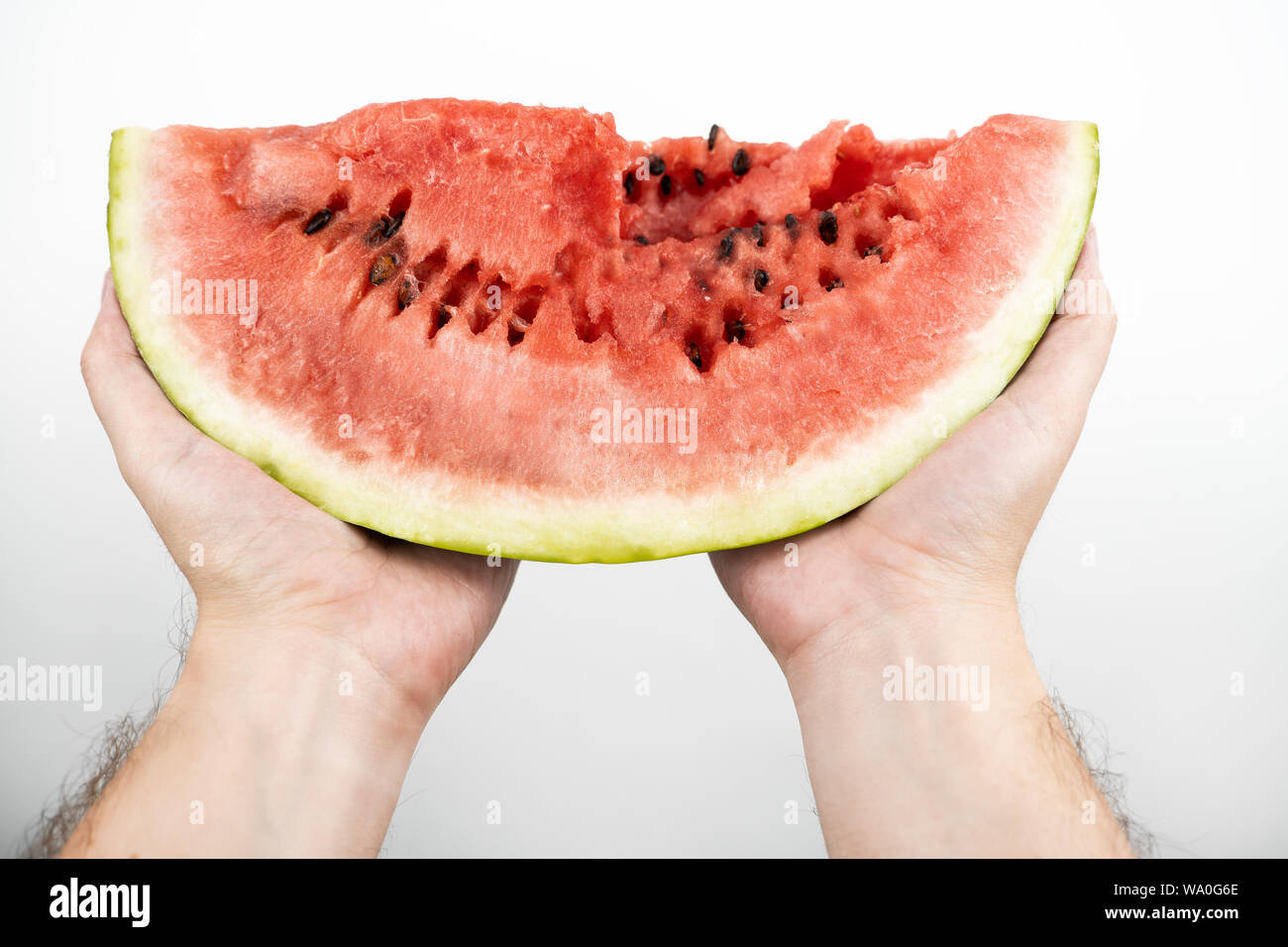 image of hands holding fresh ripe piece of watermelon on isolated white ...