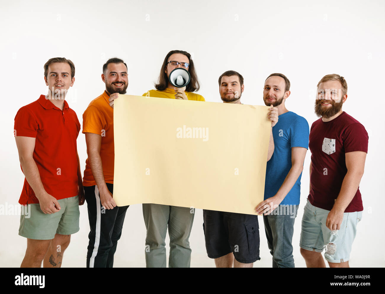 Young men weared in LGBT flag colors isolated on white background ...