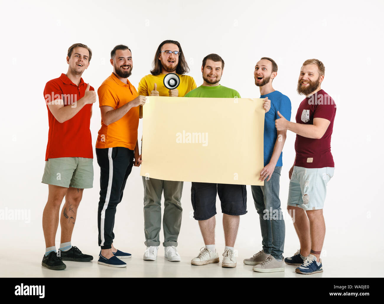 Young men weared in LGBT flag colors isolated on white background ...