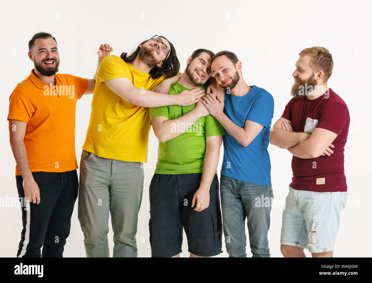 Young men weared in LGBT flag colors isolated on white background ...