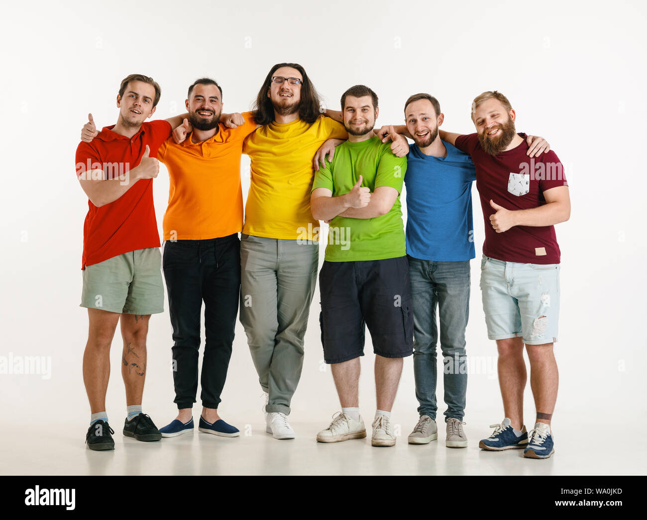 Young men weared in LGBT flag colors isolated on white background ...