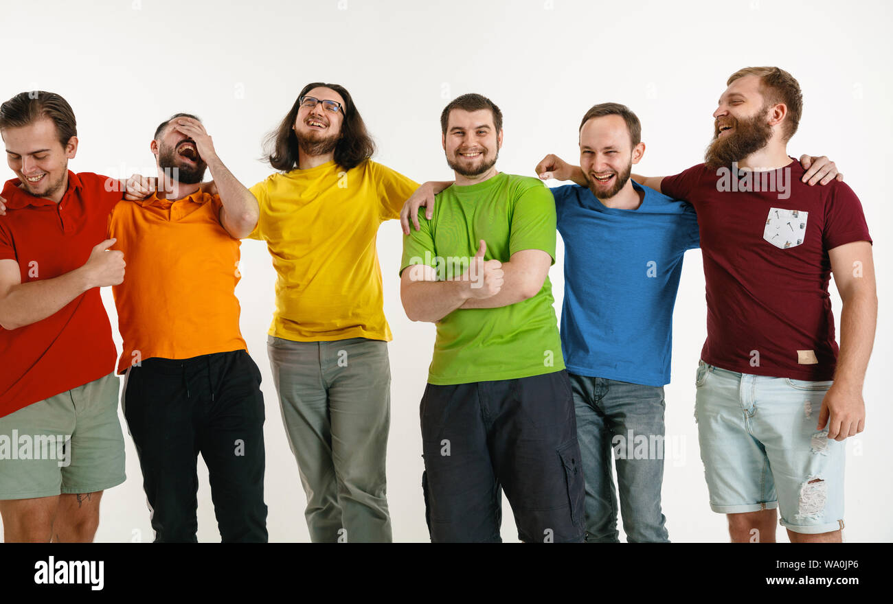 Young men weared in LGBT flag colors isolated on white background ...