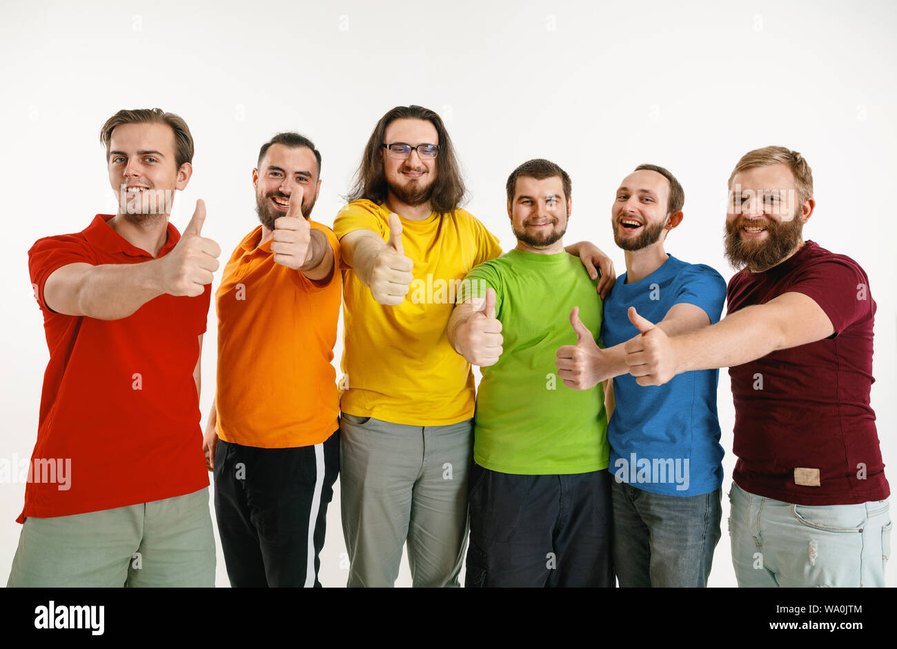 Young men weared in LGBT flag colors isolated on white background ...