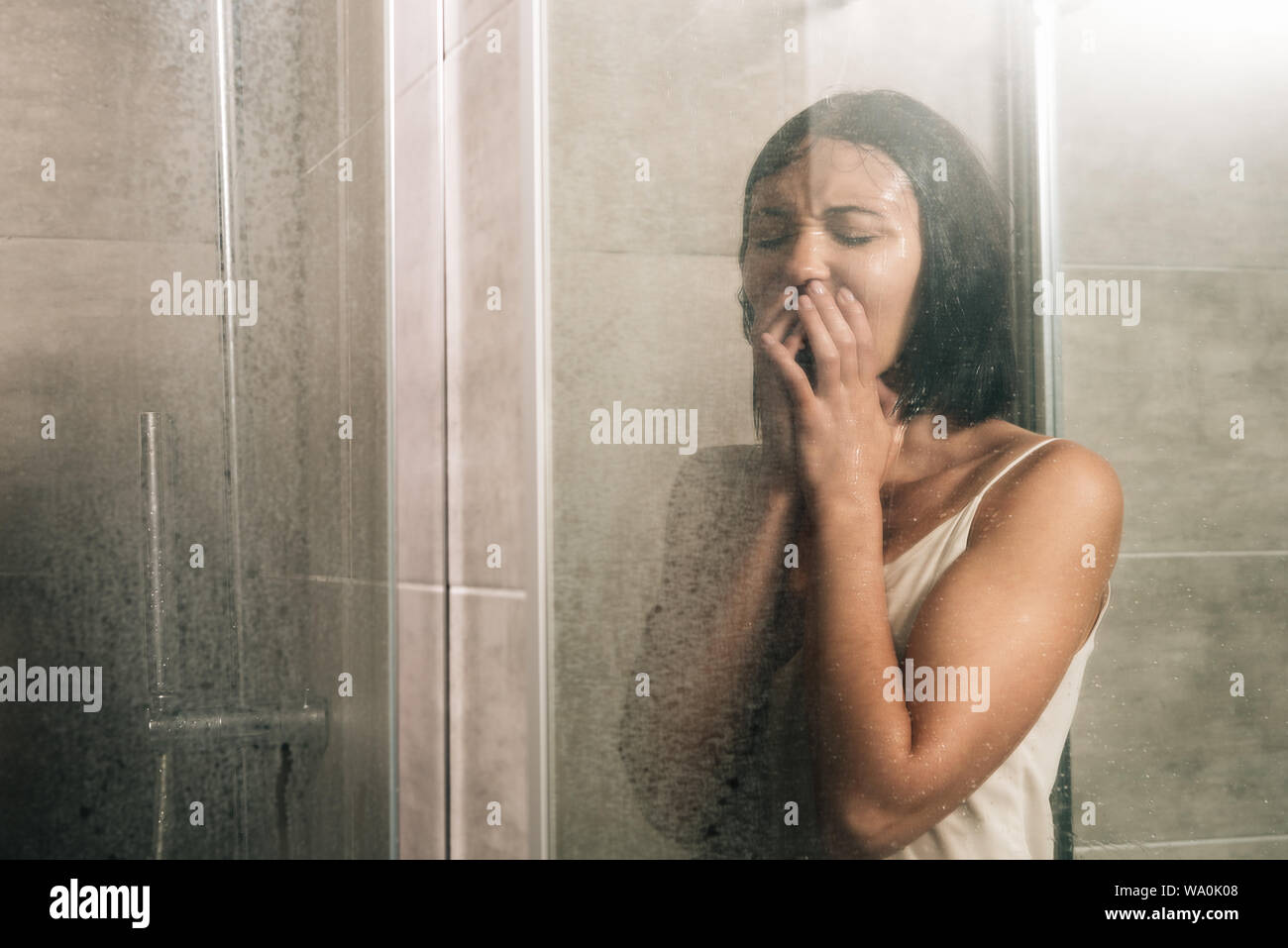 Sad woman crying in bathroom hi-res stock photography and images - Alamy