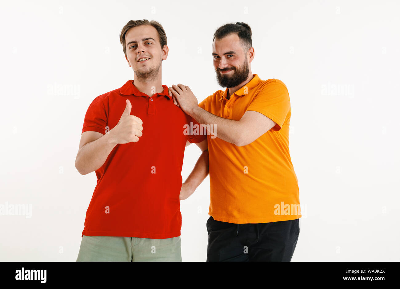 Young men weared in LGBT flag colors isolated on white background ...