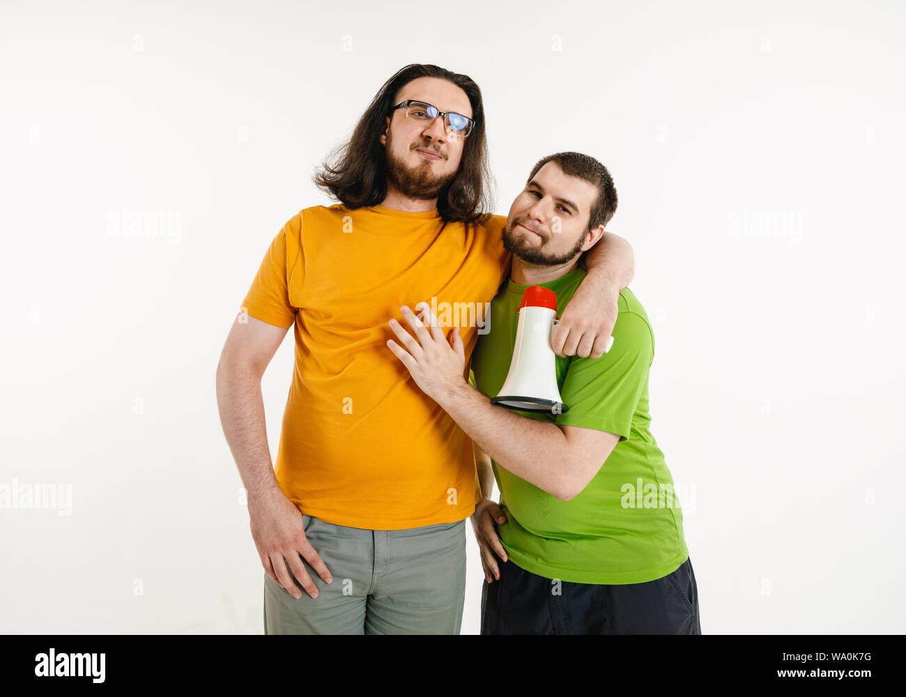 Young men weared in LGBT flag colors on white background. Caucasian ...