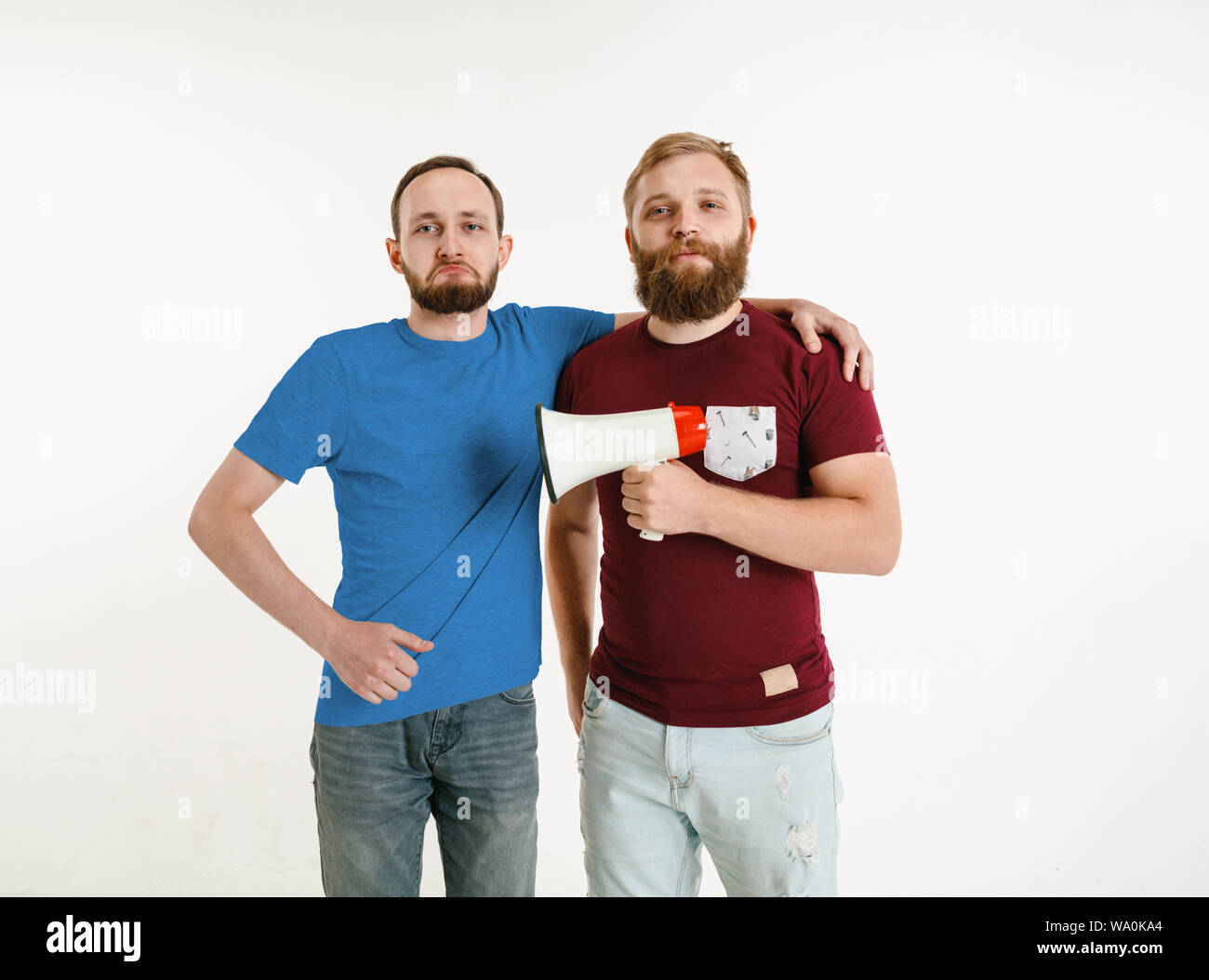 Young men weared in LGBT flag colors on white background. Caucasian ...